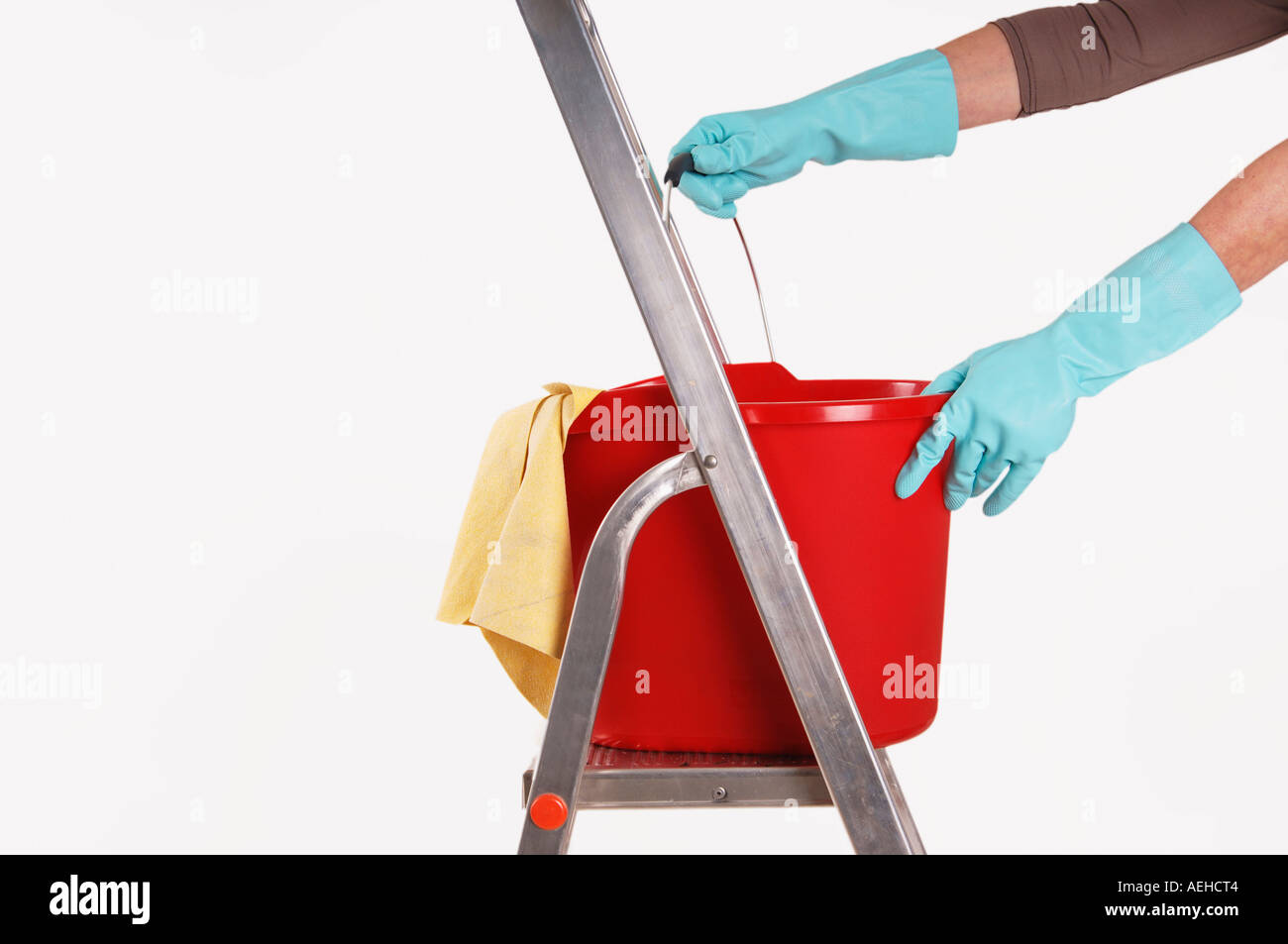 Person keeping plastic bucket on step ladder Stock Photo - Alamy