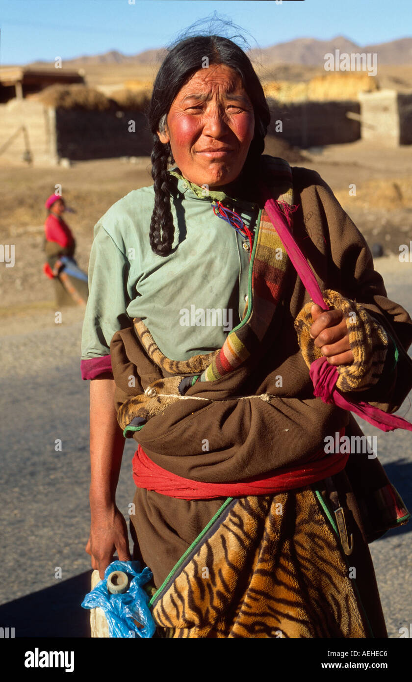Tibetan Nomad woman wearing fake animal skin on the Sangke Grasslands ...