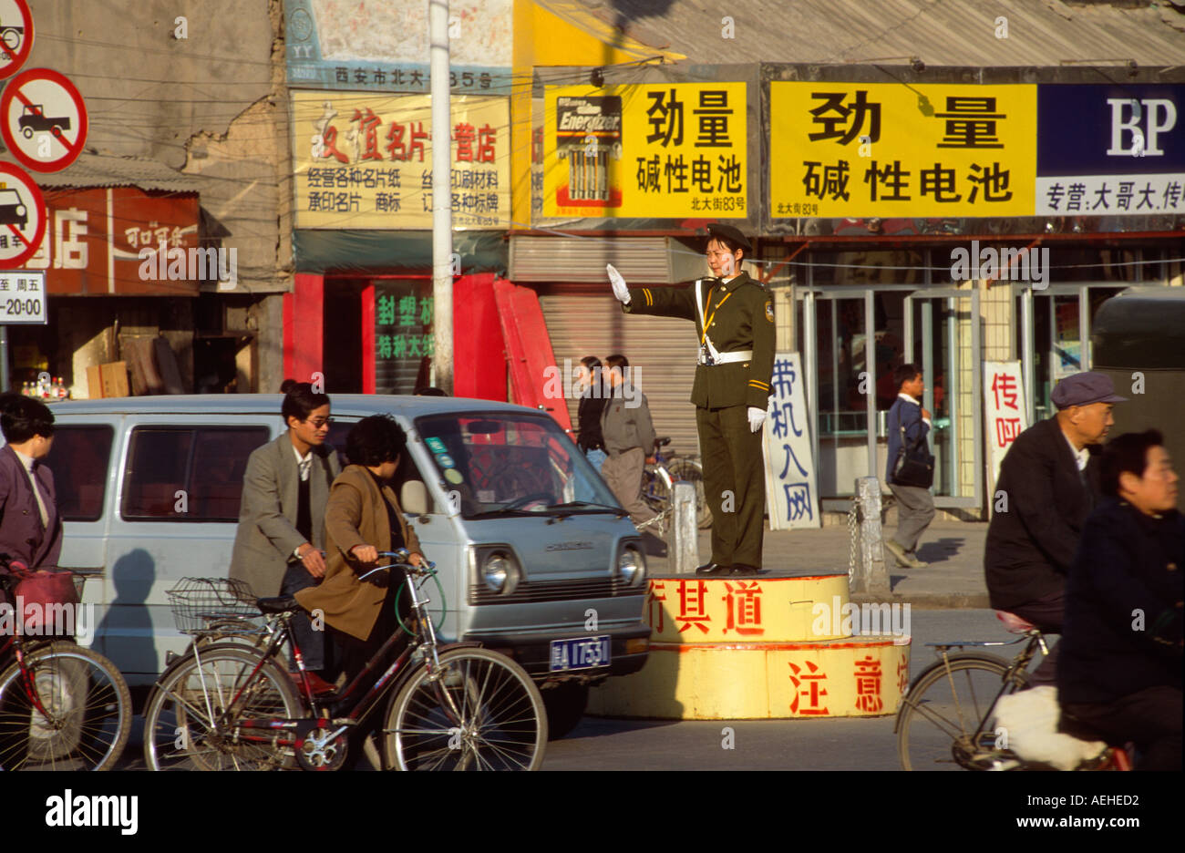 Traffic policewoman directing traffic at a busy intersection, Xian ...