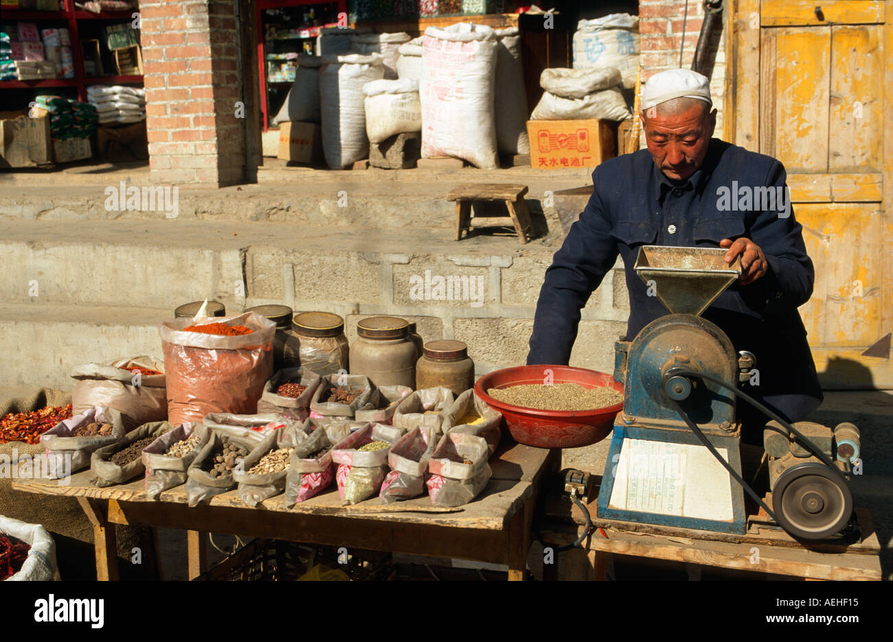 Chinese Muslim spice trader with his grinder on the streets of Xiahe ...