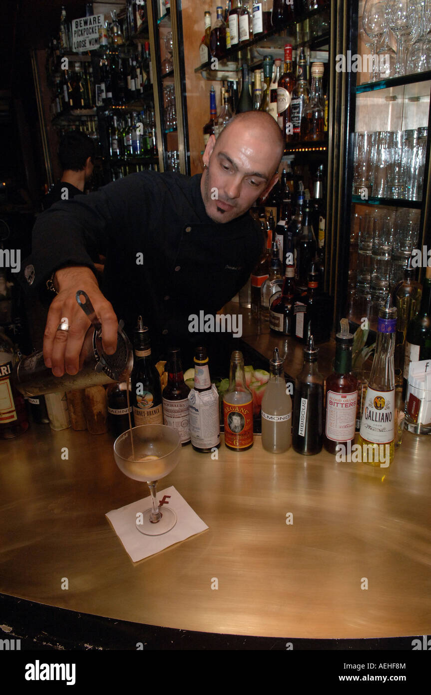 Bartender pours mixed drink at Employees Only bar in Greenwich Village ...