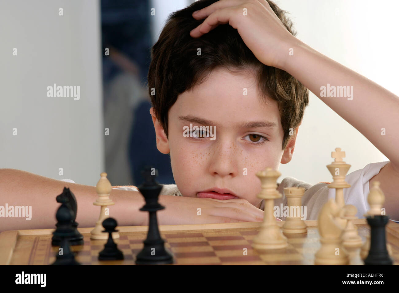 Boy playing chess Stock Photo - Alamy