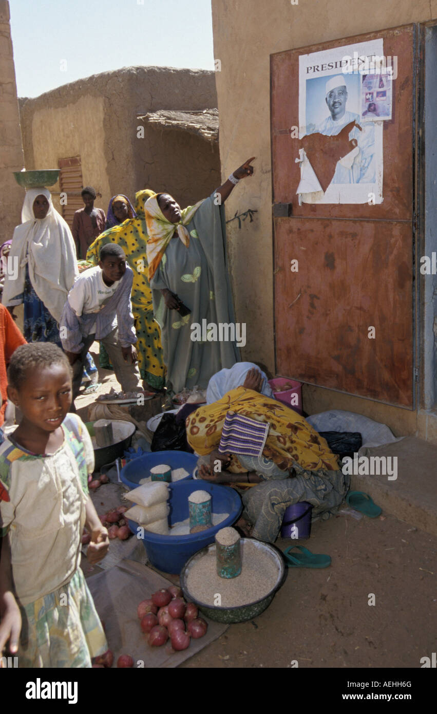 Mali Ansongo Woman showing poster of president of Mali Stock Photo - Alamy