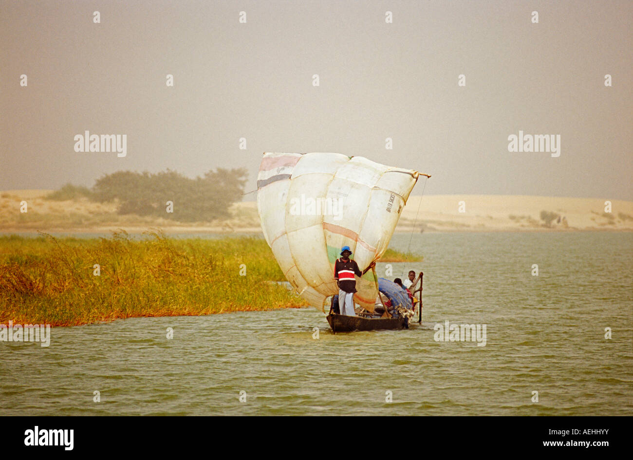 Mali Bamba, People of Songrai tribecrossing Niger river in canoe with ...