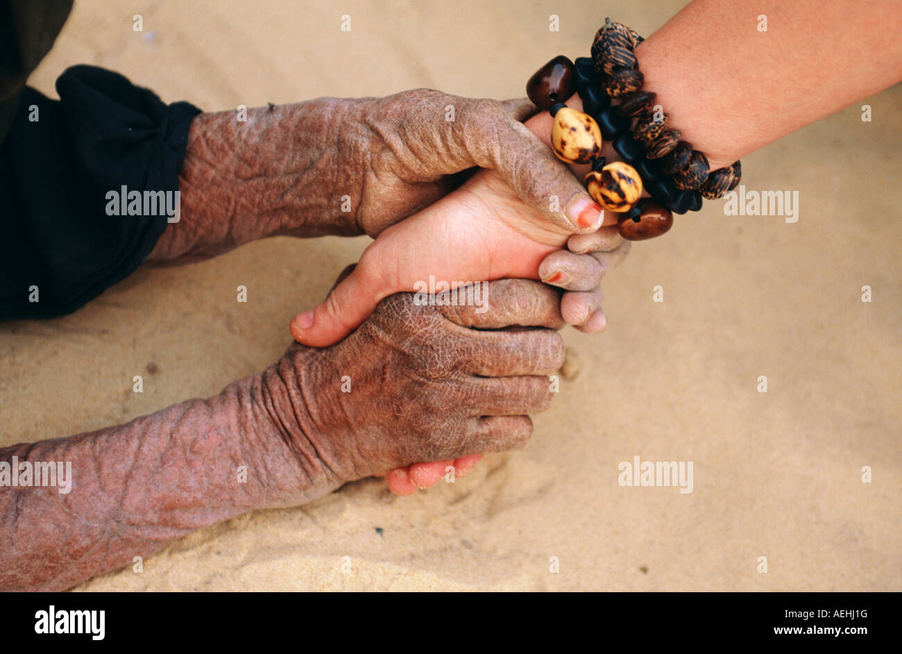 Mali Bamba, Tourist shaking hand with old woman Stock Photo - Alamy