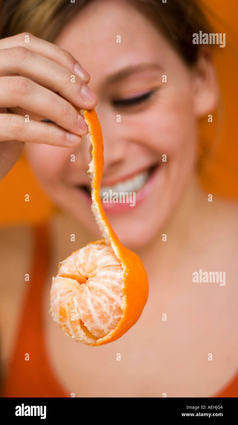 Woman peeling fresh tangerine hi-res stock photography and images - Alamy