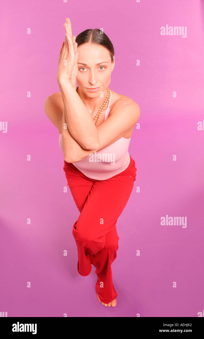 Woman doing eagle exercise Stock Photo - Alamy