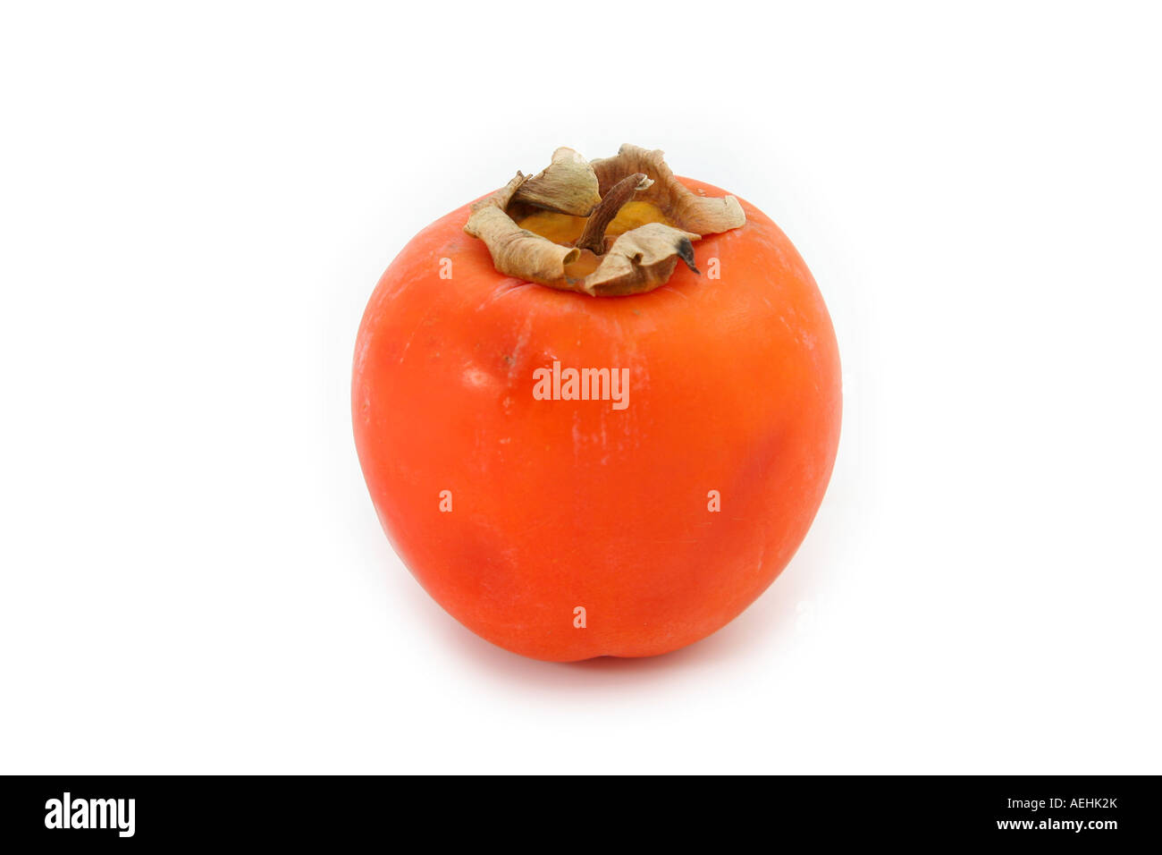 big orange persimmon isolated over white Stock Photo - Alamy
