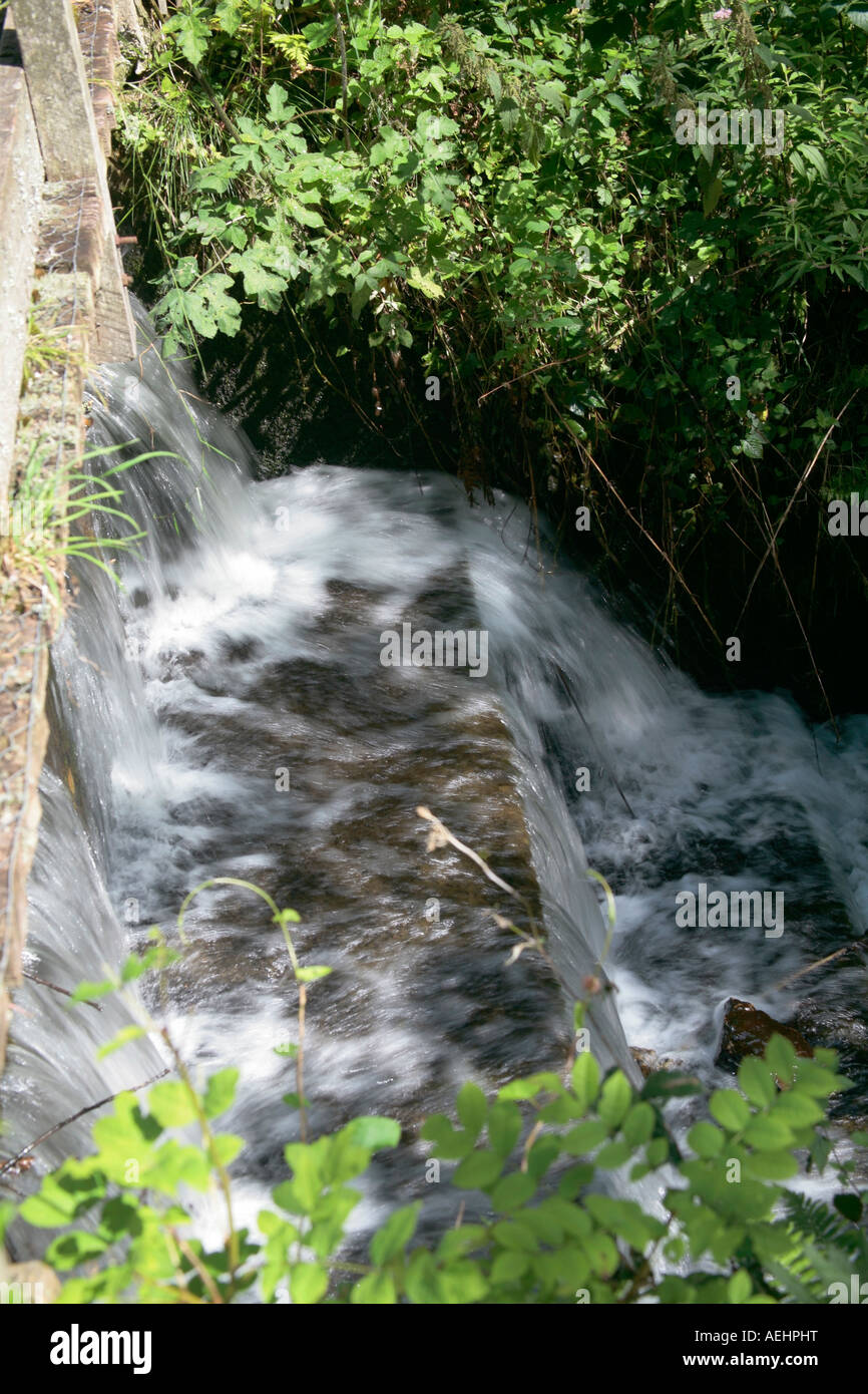 Rapid flow of water through a sluice gate Stock Photo - Alamy