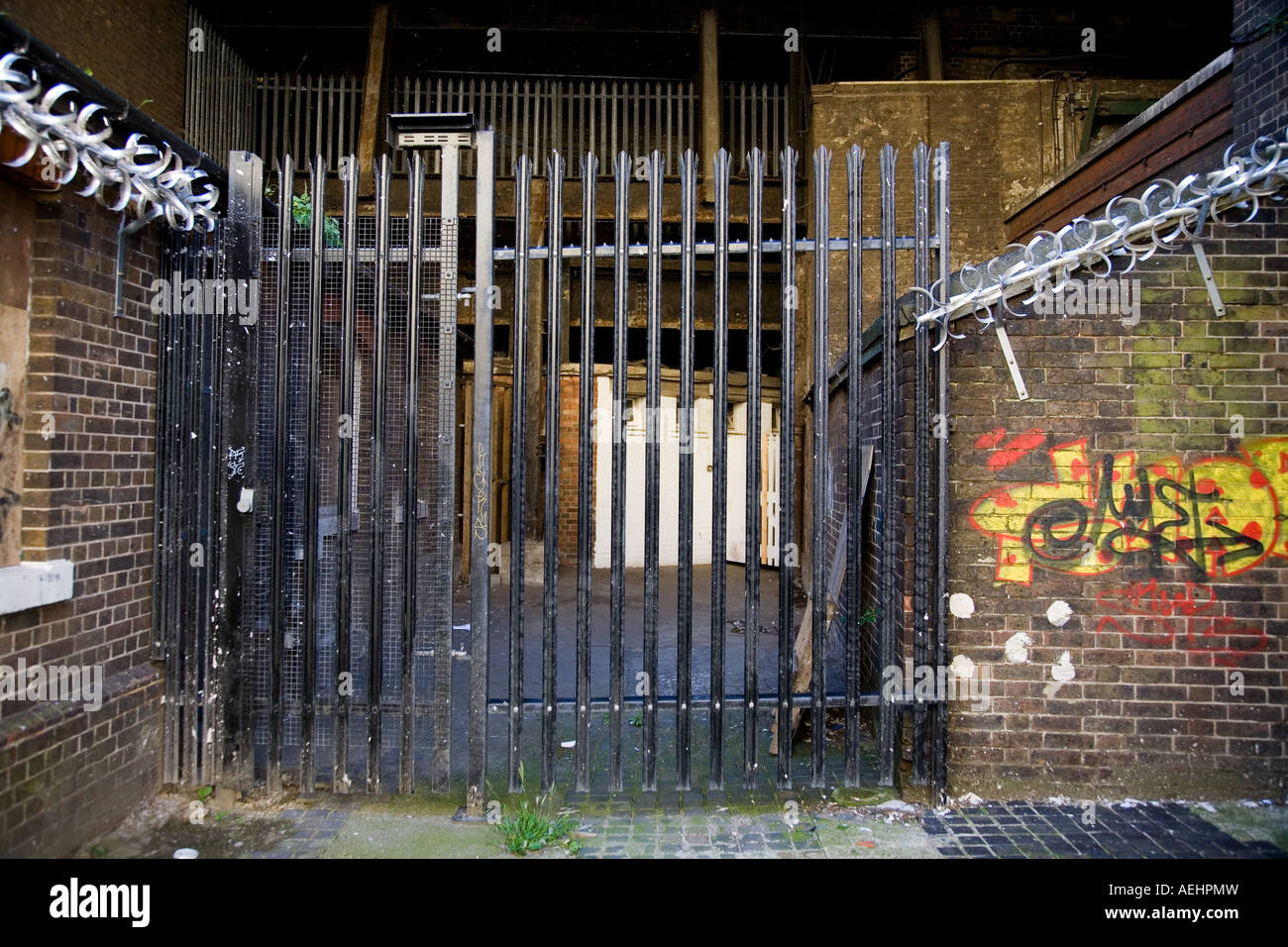 High security gate with barbed wire. Graffiti, Urban background Stock ...