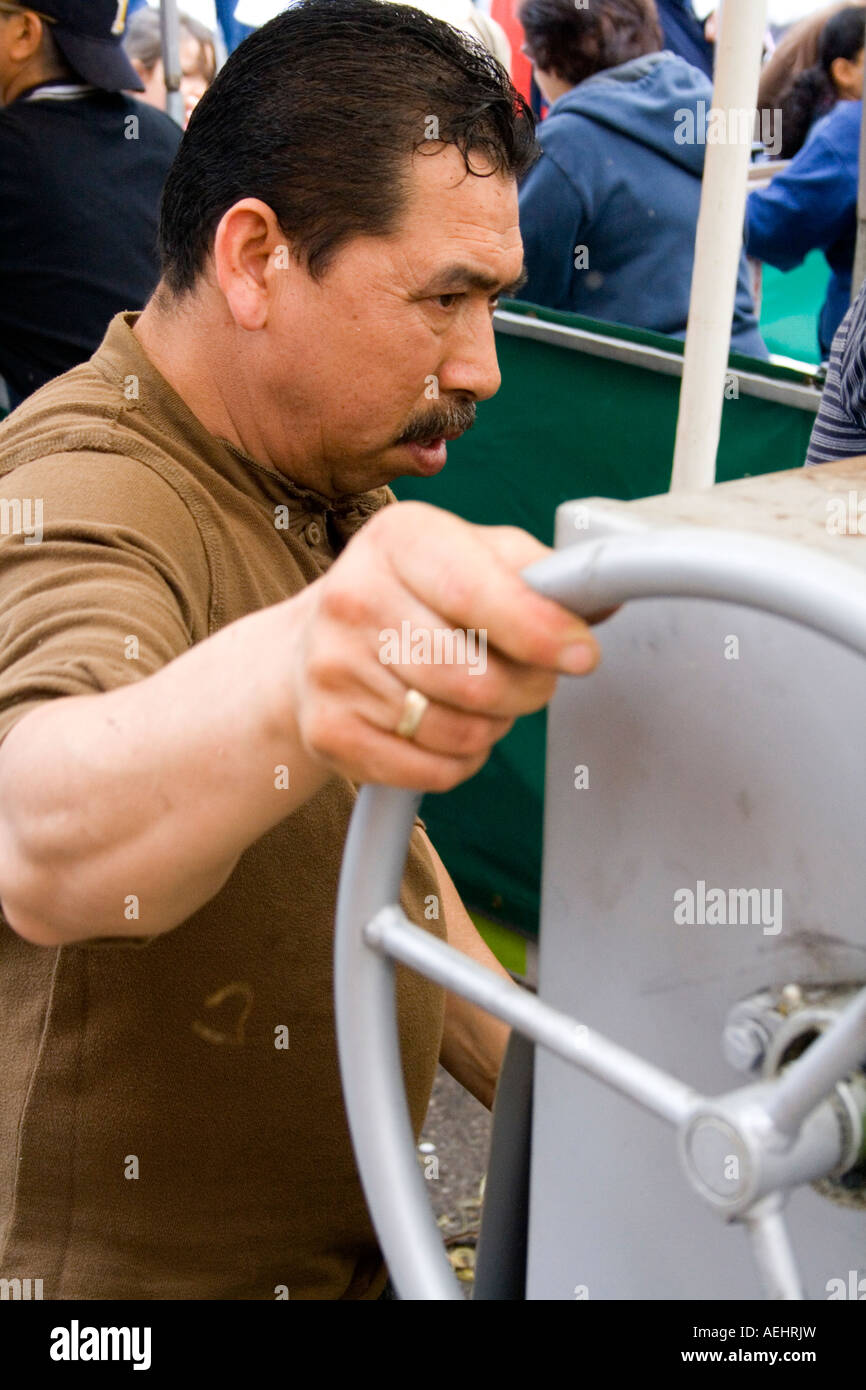 Chicano man age 32 concentrating as he turns roasting corn in oven ...