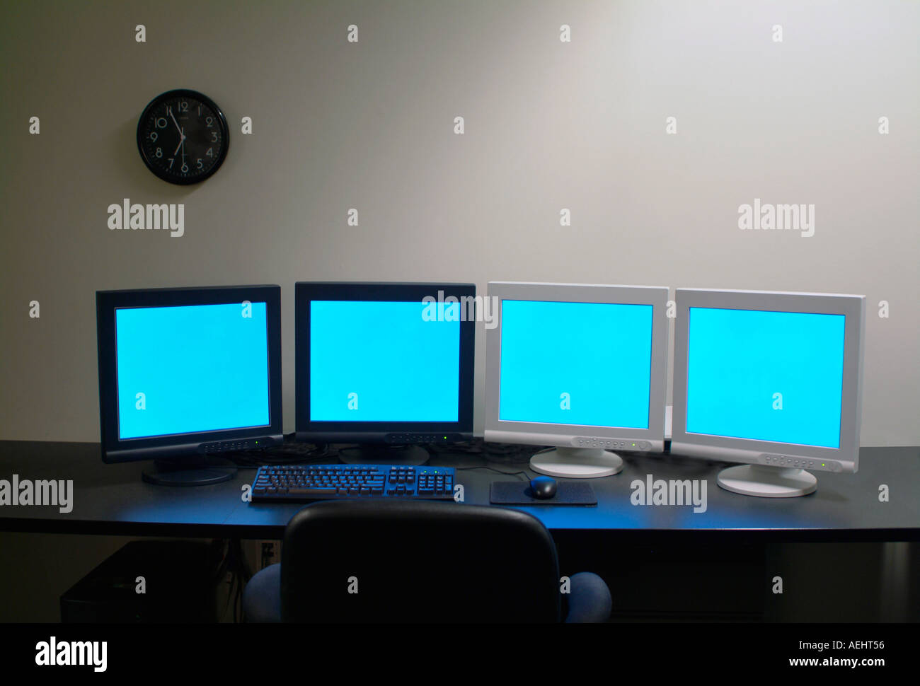 Four flat screen monitors in an office Stock Photo - Alamy