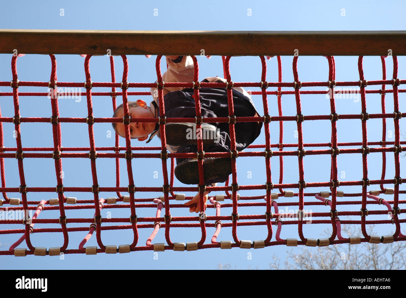 Boy climbing on bridge hi-res stock photography and images - Alamy