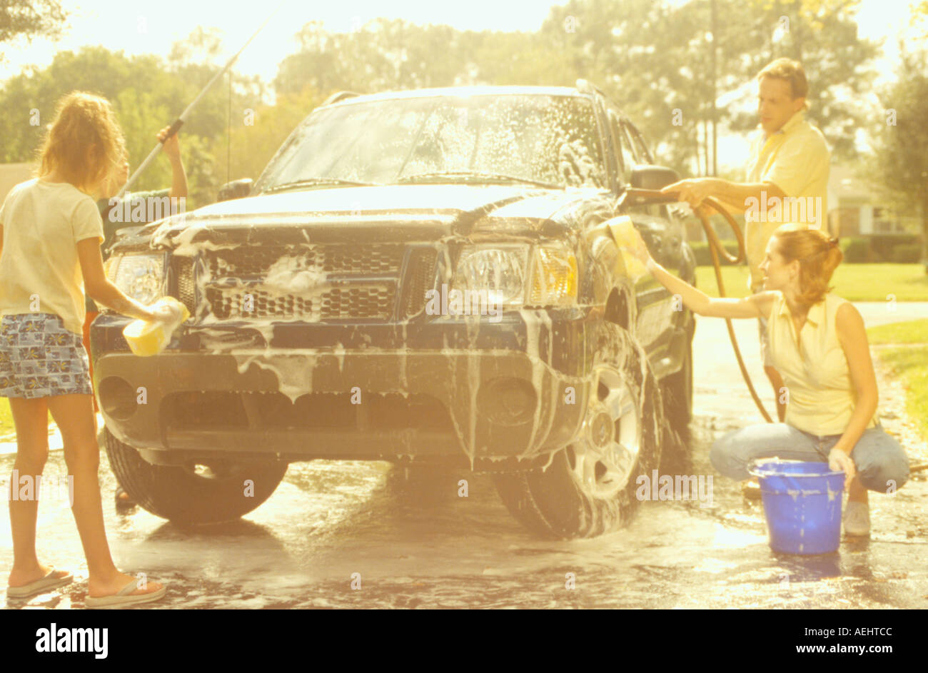 Family washing car in driveway Stock Photo - Alamy