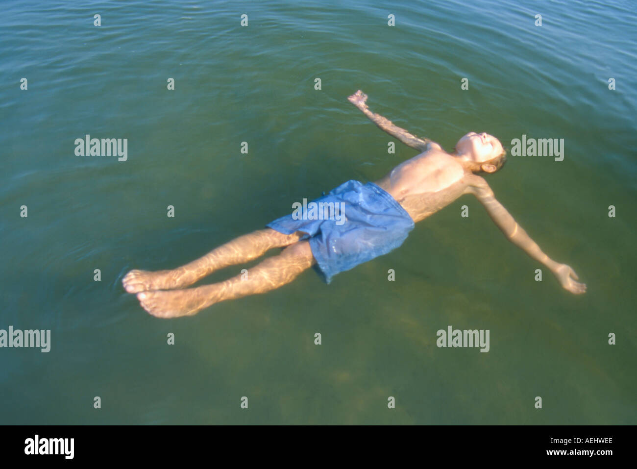 Boy floating in his back Stock Photo - Alamy