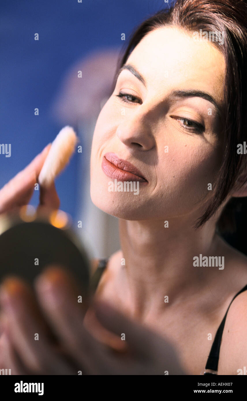 Woman powdering face Stock Photo - Alamy