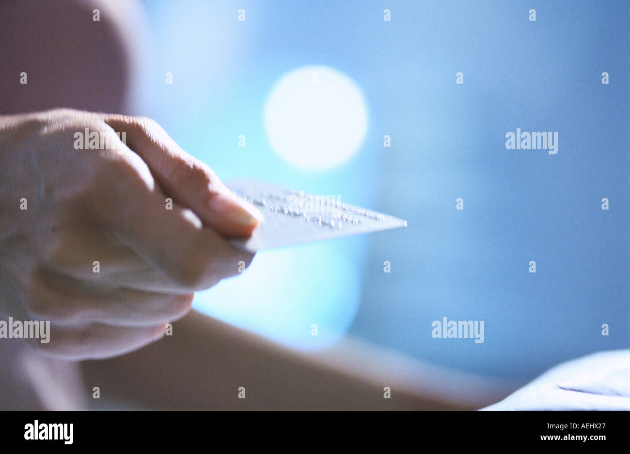 Woman giving credit card to salesperson Stock Photo - Alamy