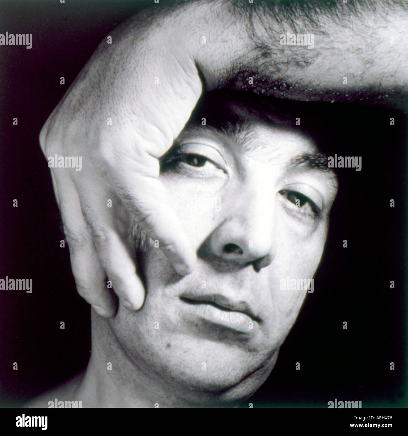 Man with hand on face Stock Photo - Alamy