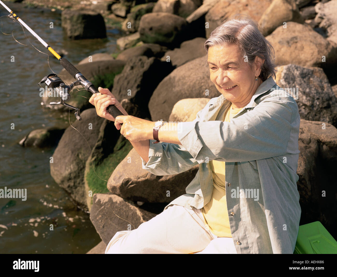 Older woman fishing Stock Photo - Alamy