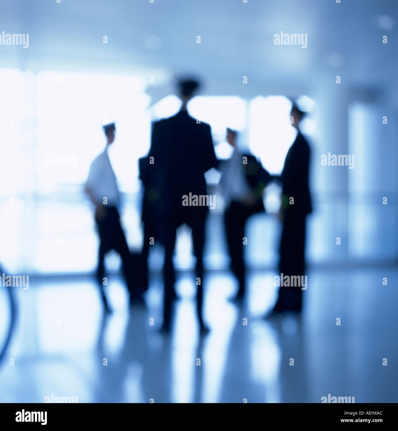 Group of pilots talking in airport Stock Photo - Alamy