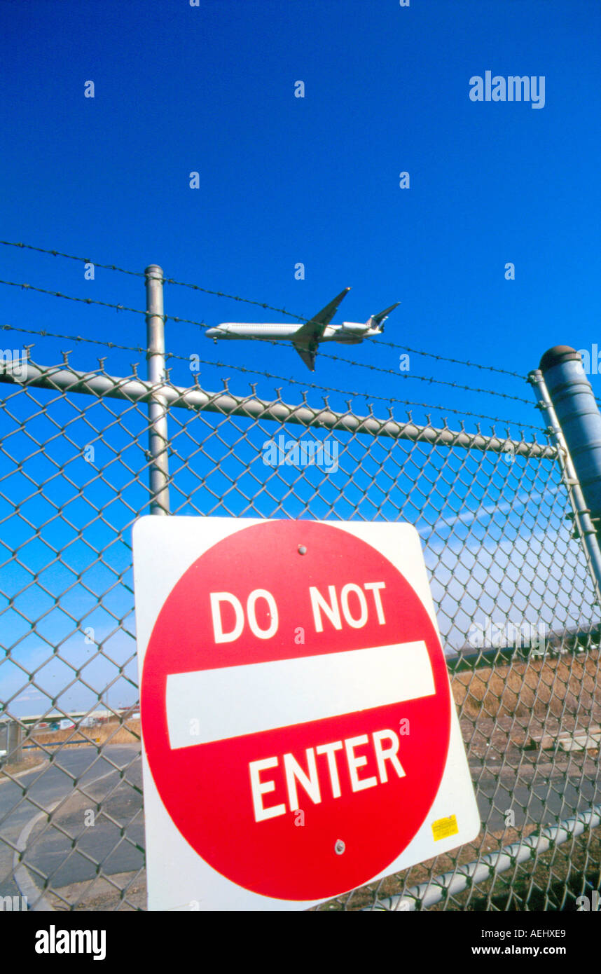 Airplane in flight with Do Not Enter sign in foreground Stock Photo - Alamy