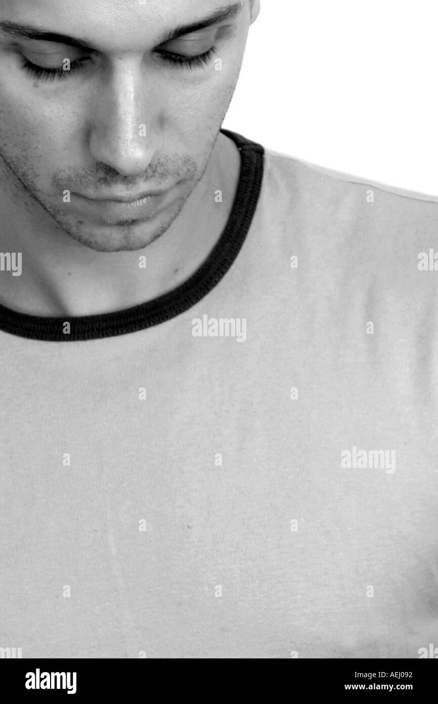 A handsome young man looks down Stock Photo - Alamy