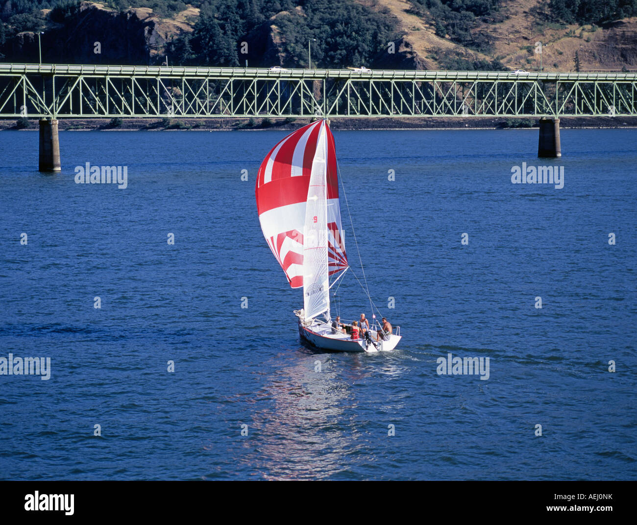 A small sailboat navigates the Columbia river near Hood River on a ...