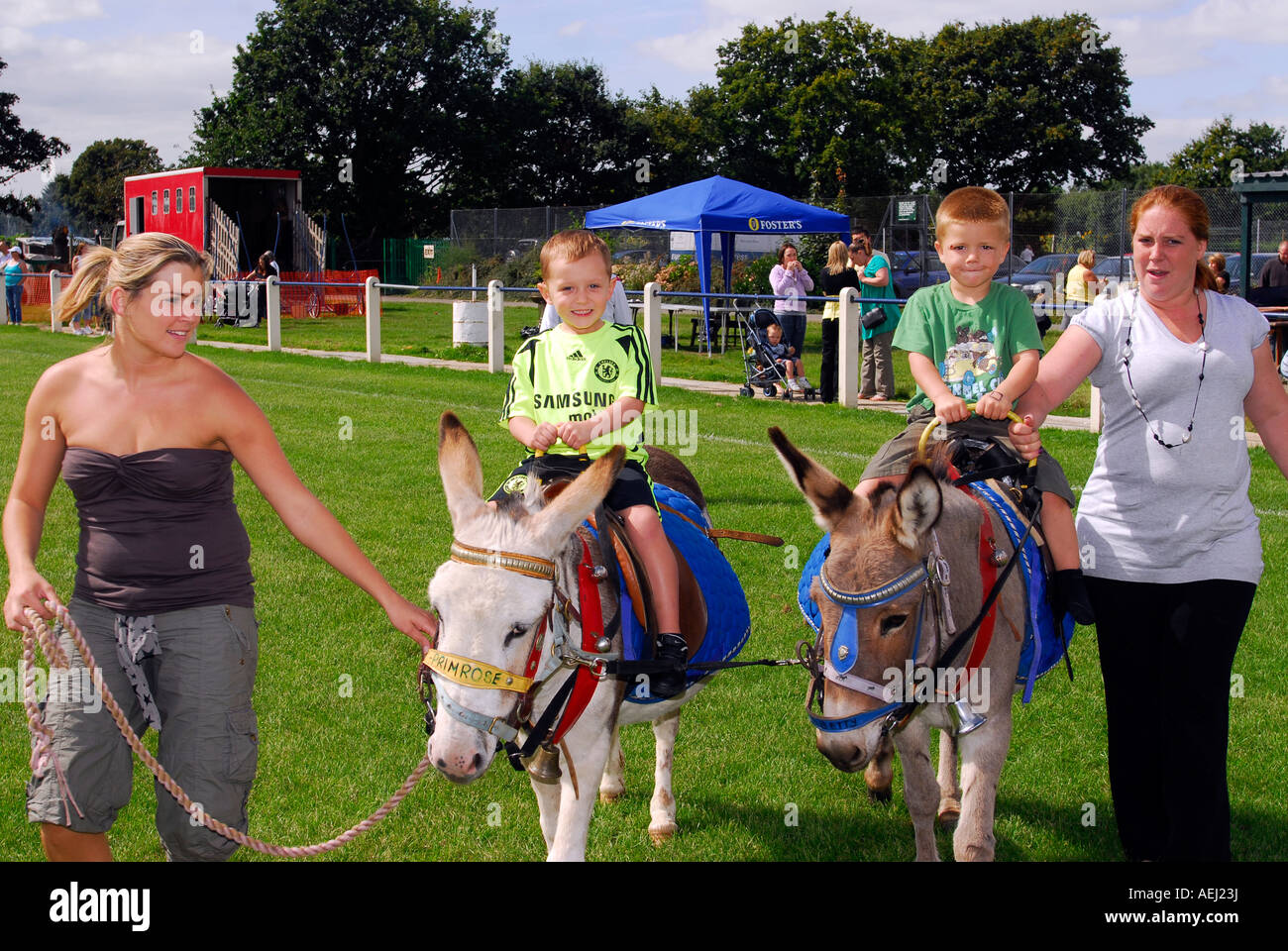 2 4 year old boys riding donkeys at a family fun day Middlesex UK Stock ...