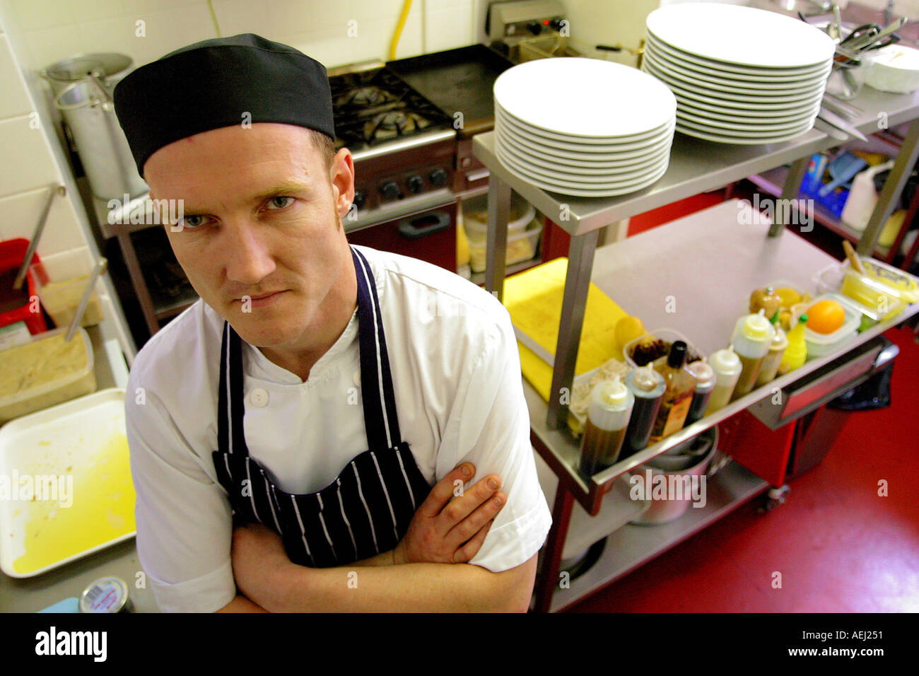 A Chef standing in his kitchen Stock Photo - Alamy