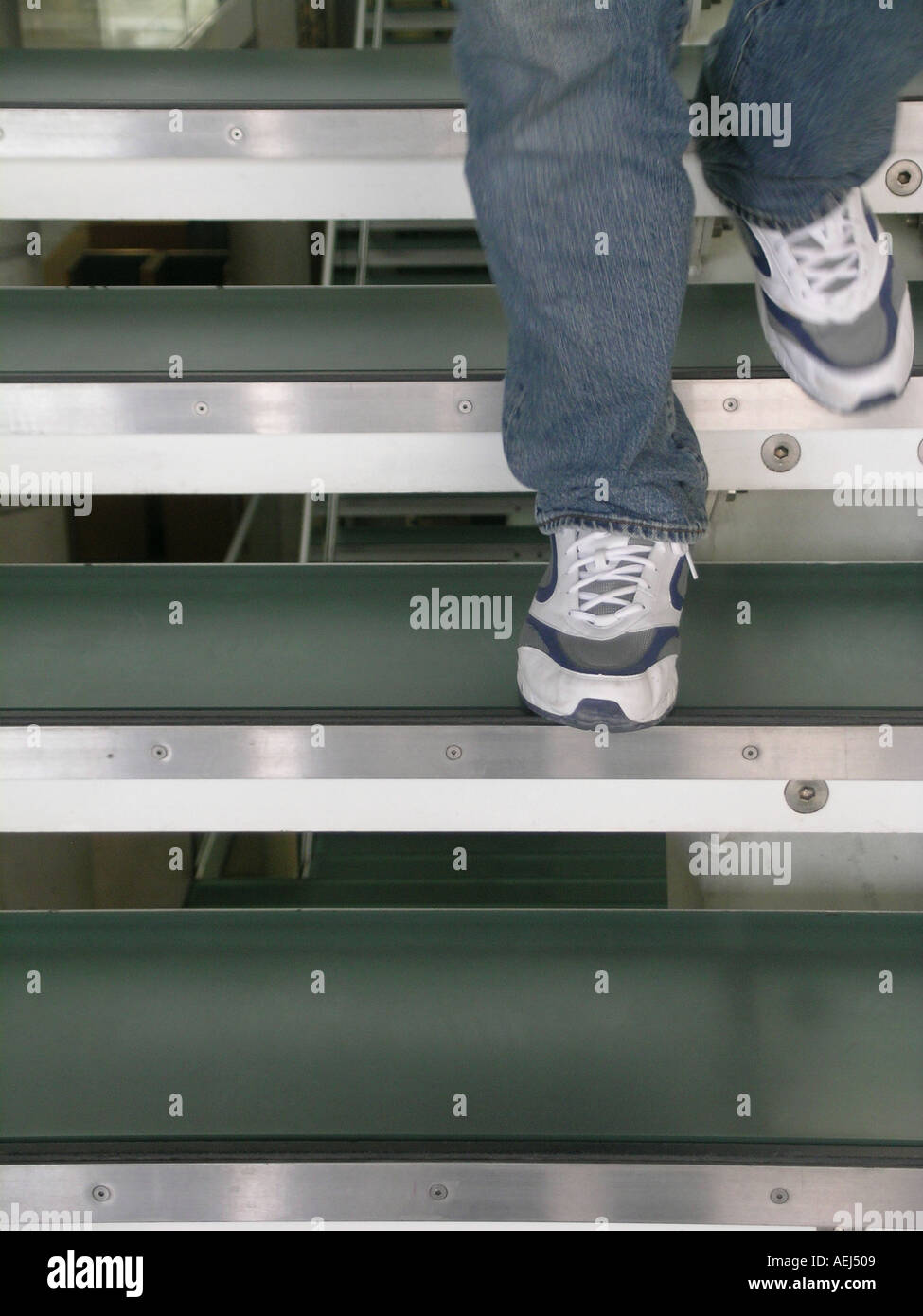 man in jeans walking down steps Stock Photo - Alamy