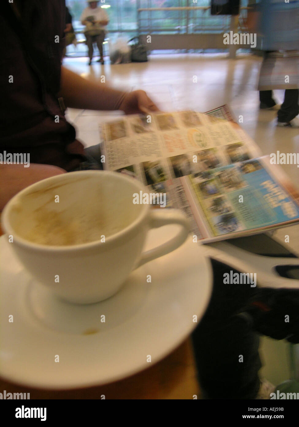 Man waiting in cafe with newspaper and coffee cup Stock Photo - Alamy