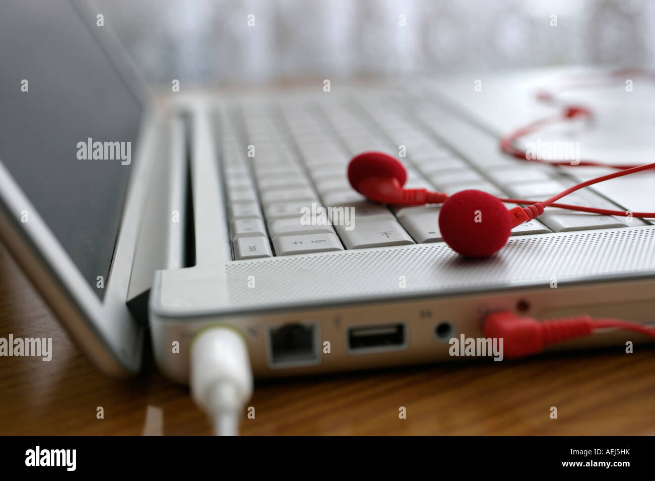 Computer keyboard with earplugs Stock Photo - Alamy