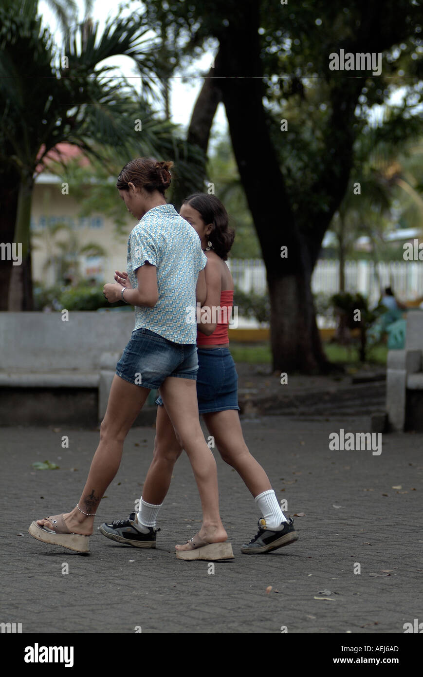 Two Costa Rican girls walking in the street Stock Photo - Alamy