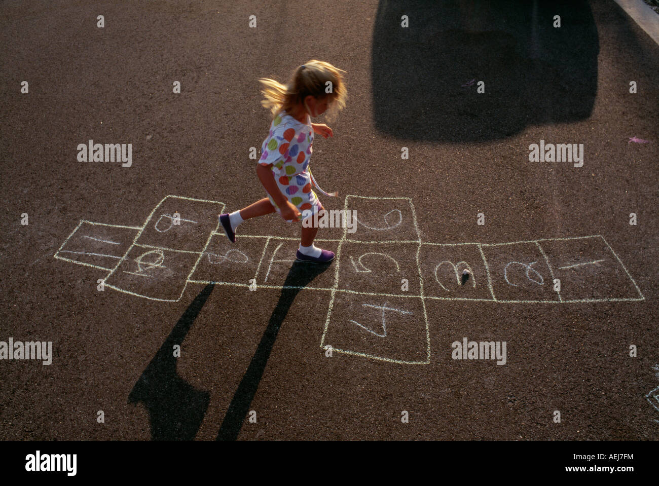 Girl playing hopscotch elevated view Stock Photo - Alamy