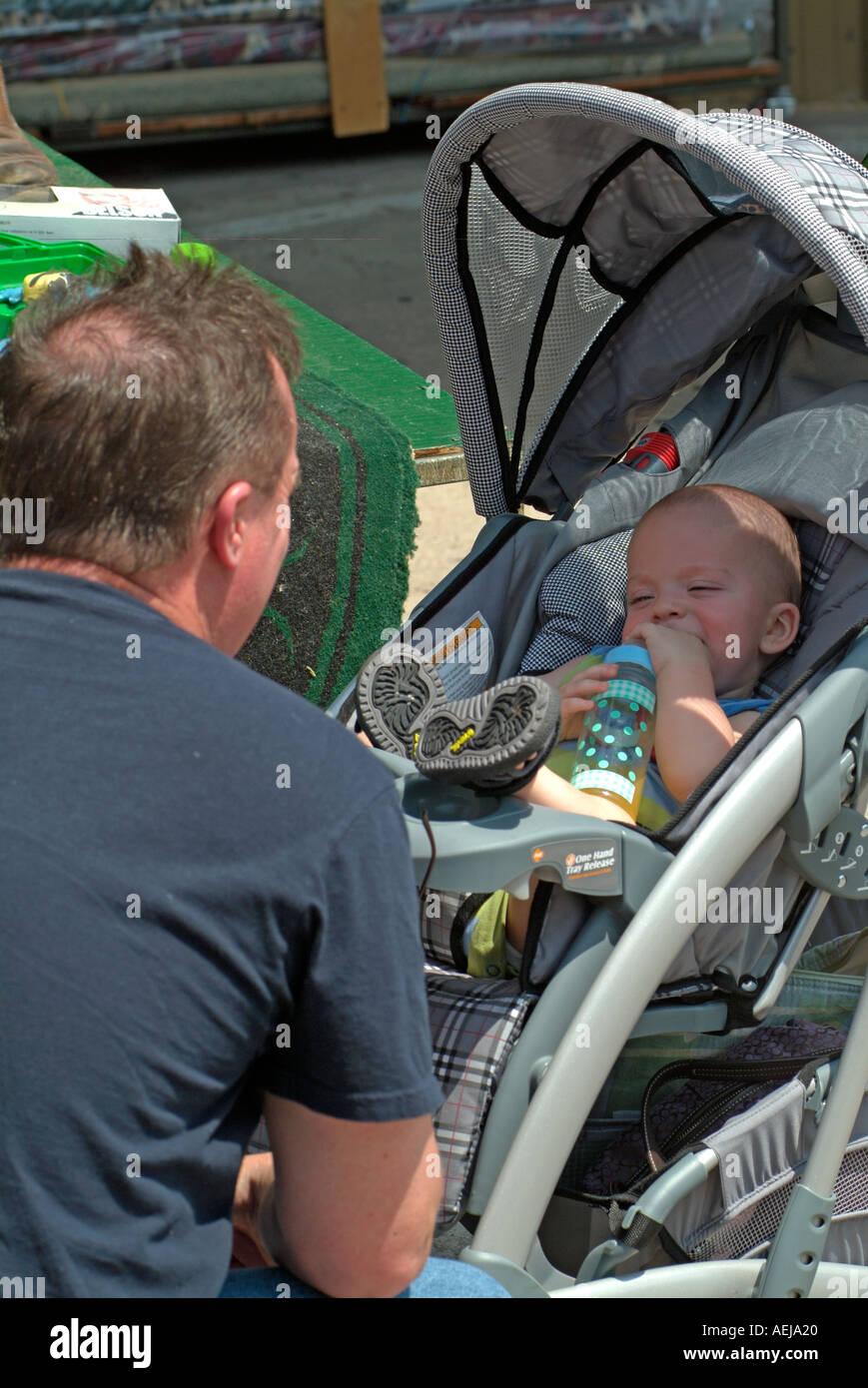 Man cuddling his child in a baby-carriage Stock Photo - Alamy