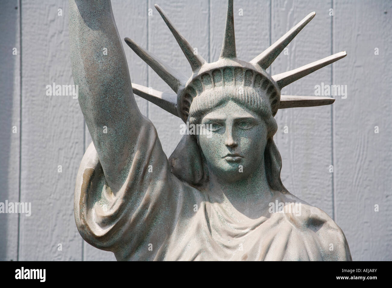 Statue of Liberty, man-sized figure in front of a boarding, Manhattan ...