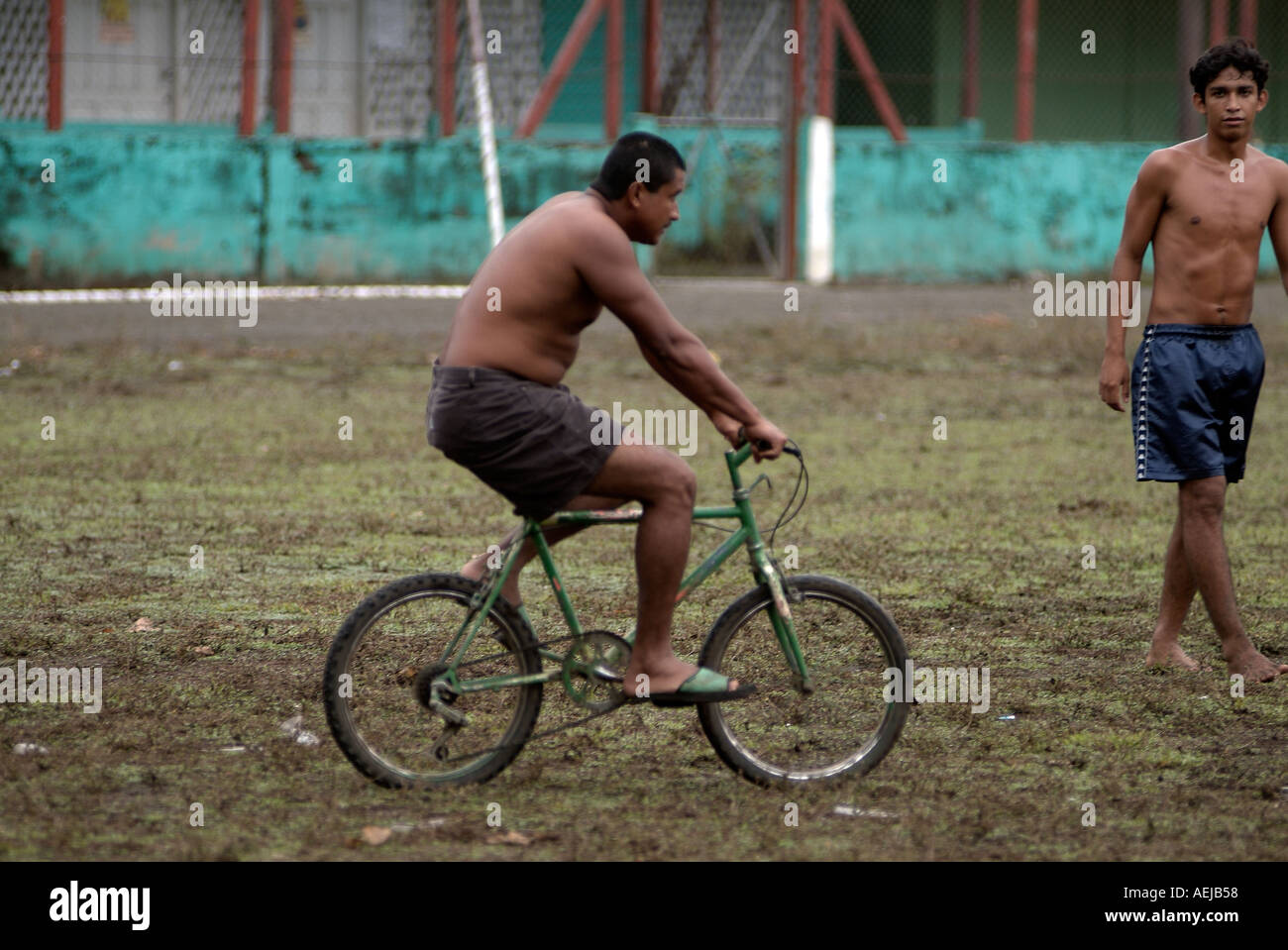 Man riding a bike and crossing in a soccer field in Costa Rica Stock ...
