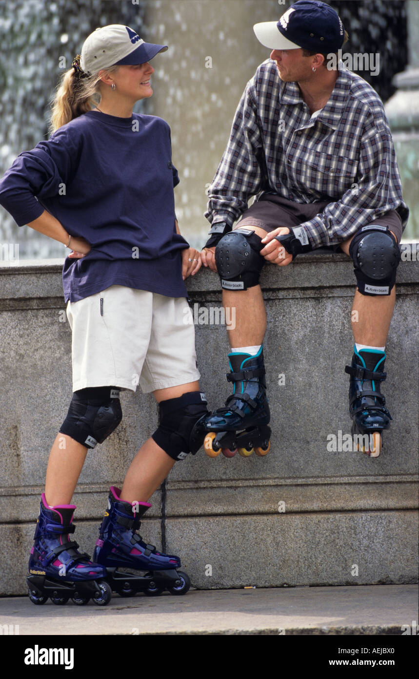 Couple wearing roller skates, smiling Stock Photo - Alamy