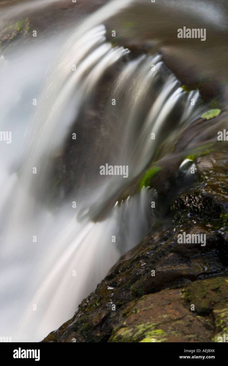 Close up of stream water flowing over rock Stock Photo - Alamy