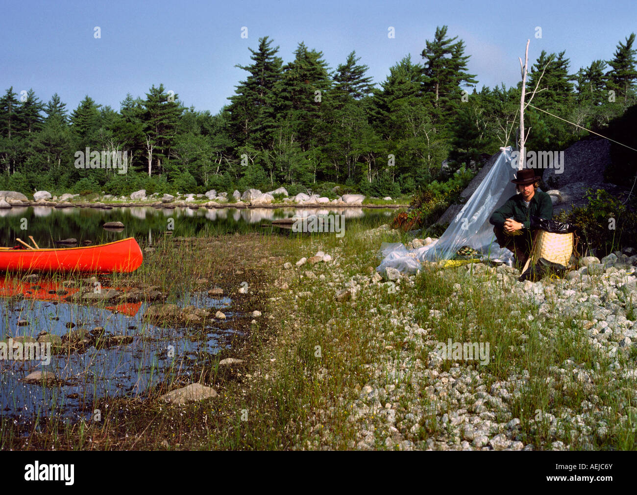 a canoe camper on a lake shore Stock Photo - Alamy