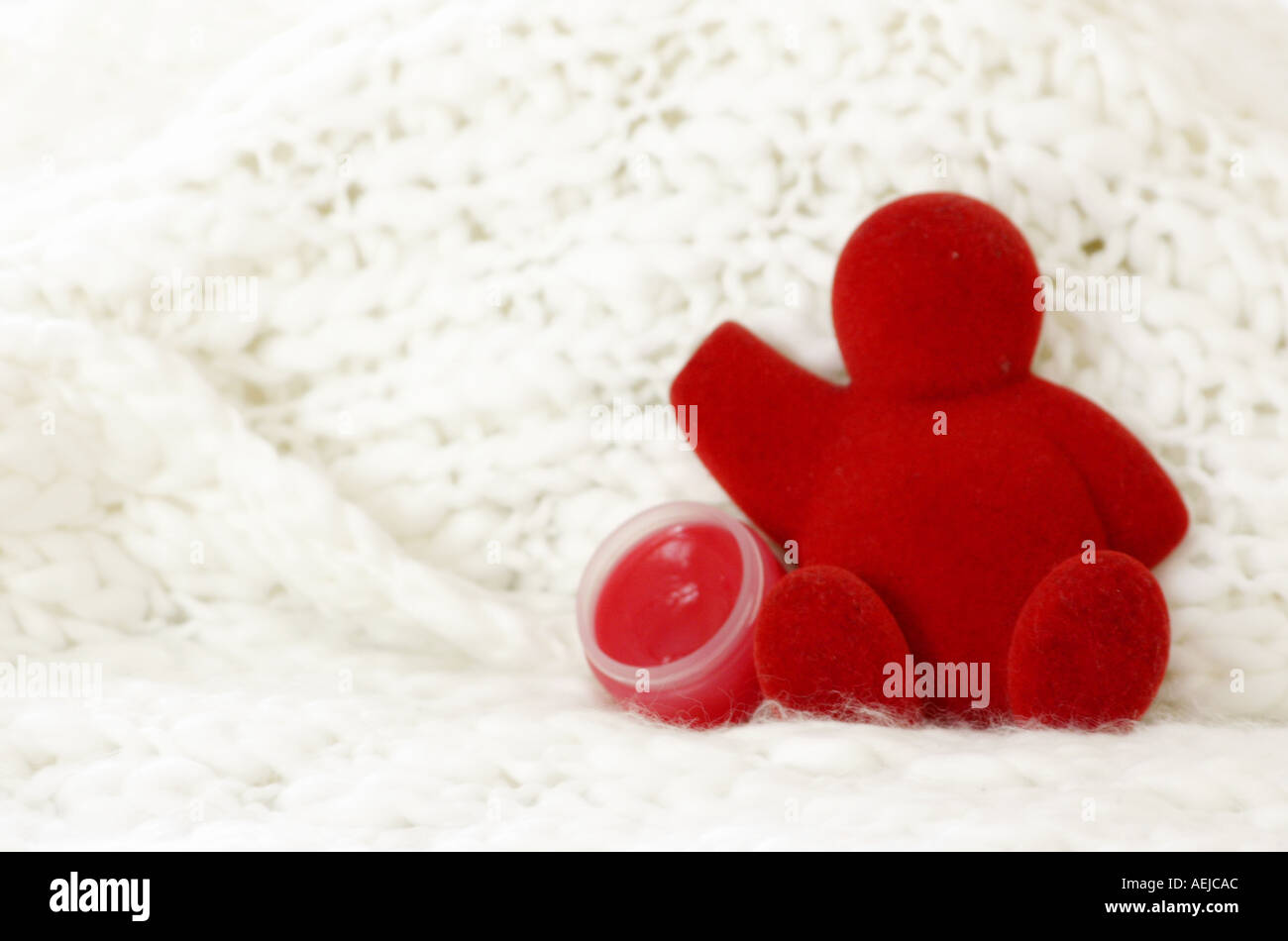 Red soft puppet sitting on soft white fabric Stock Photo - Alamy