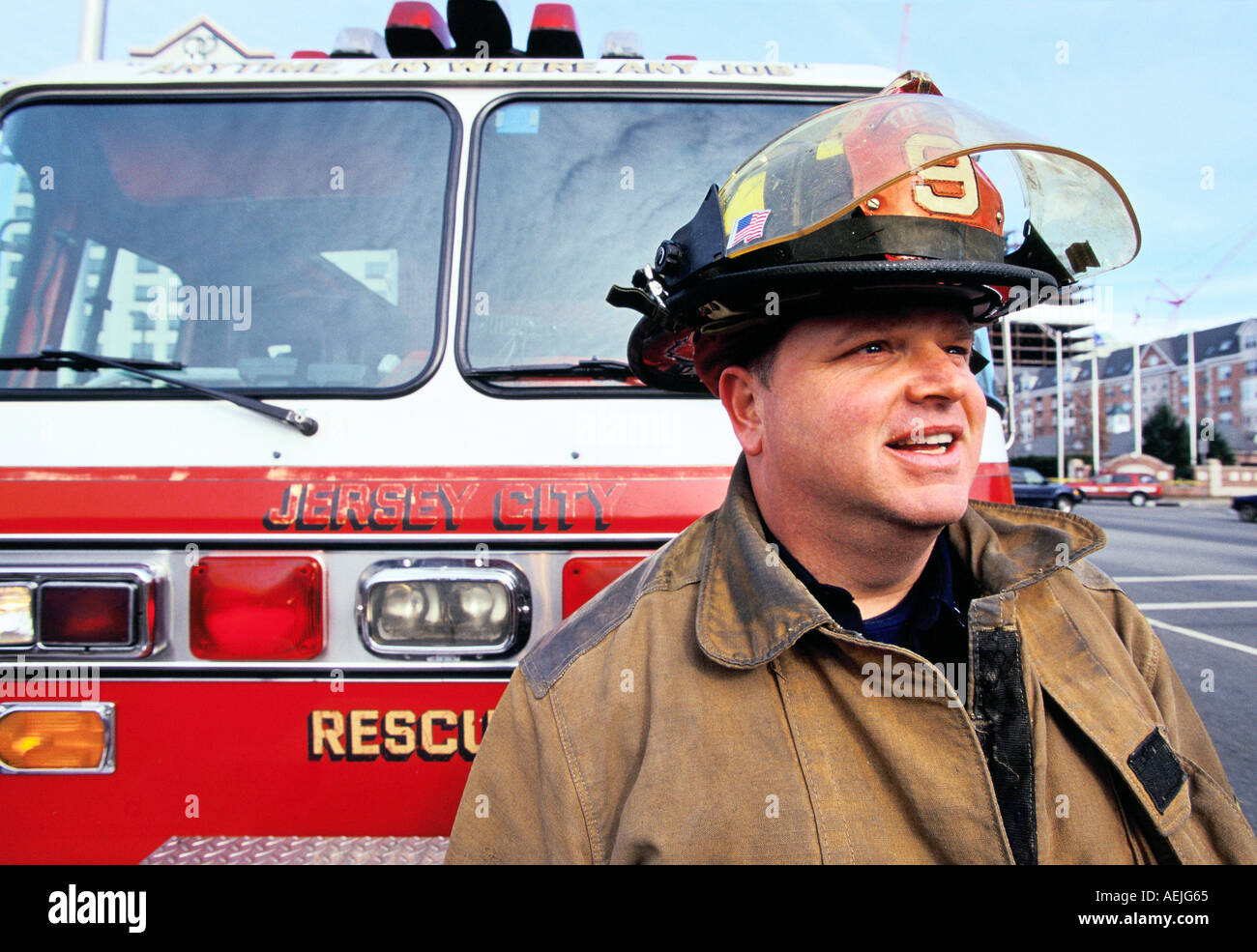 Fireman in front of truck Stock Photo - Alamy
