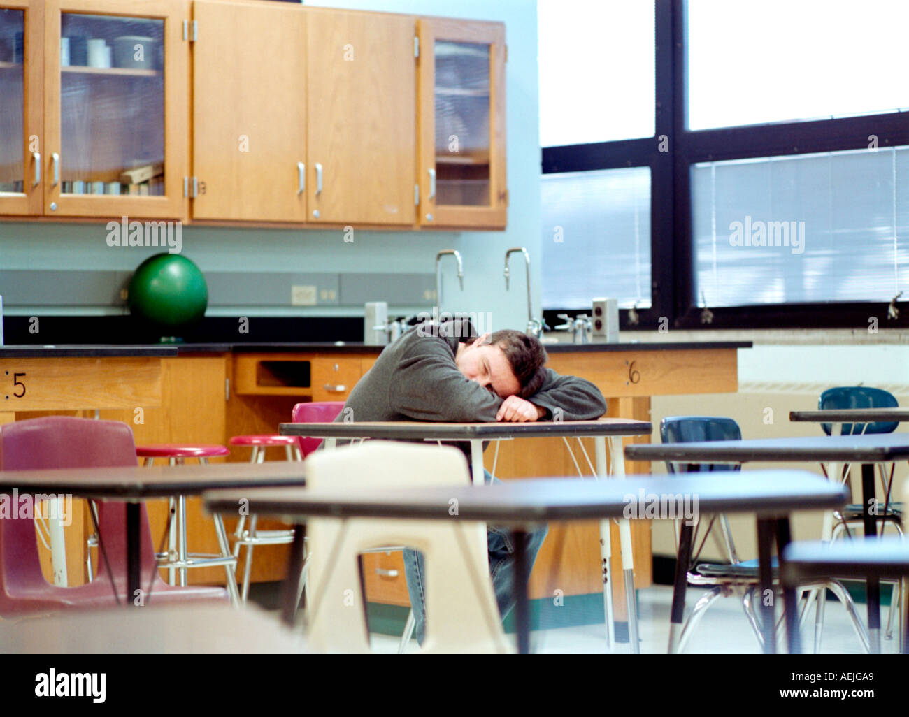 College student falling asleep on desk Stock Photo - Alamy