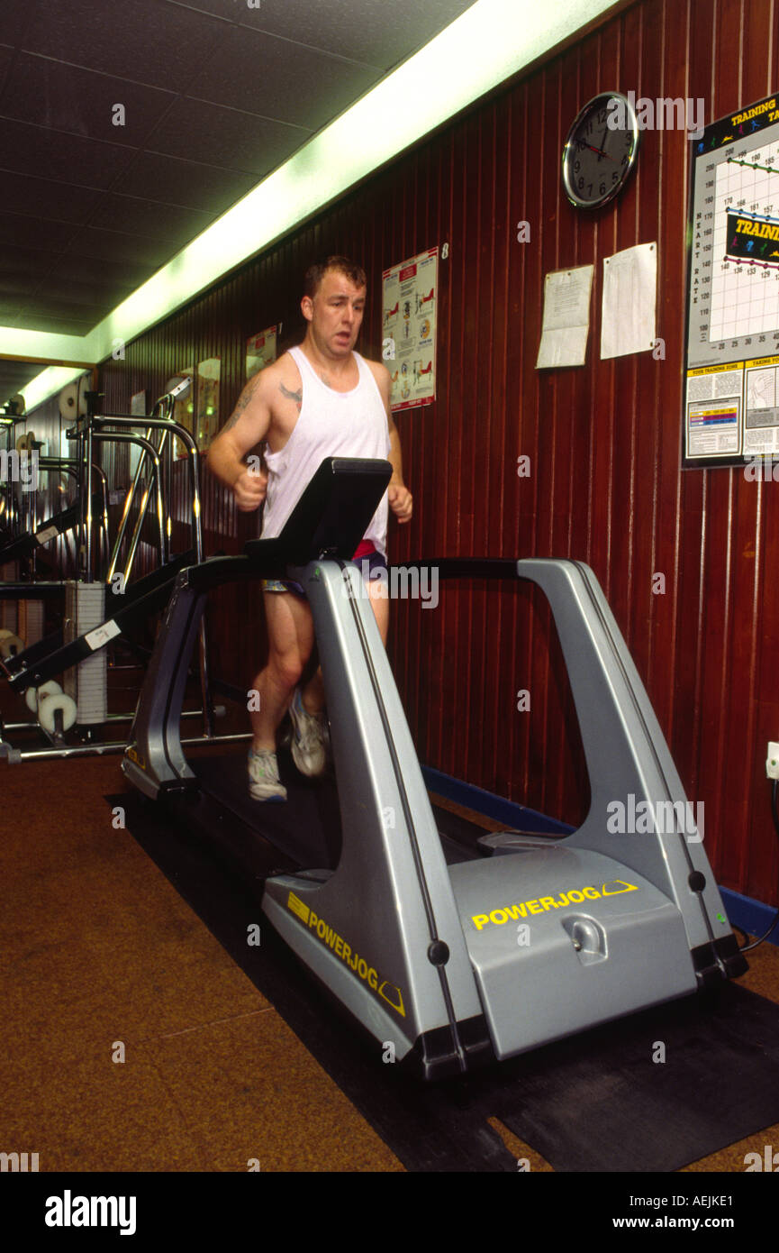 Fitness man on running machine Stock Photo - Alamy