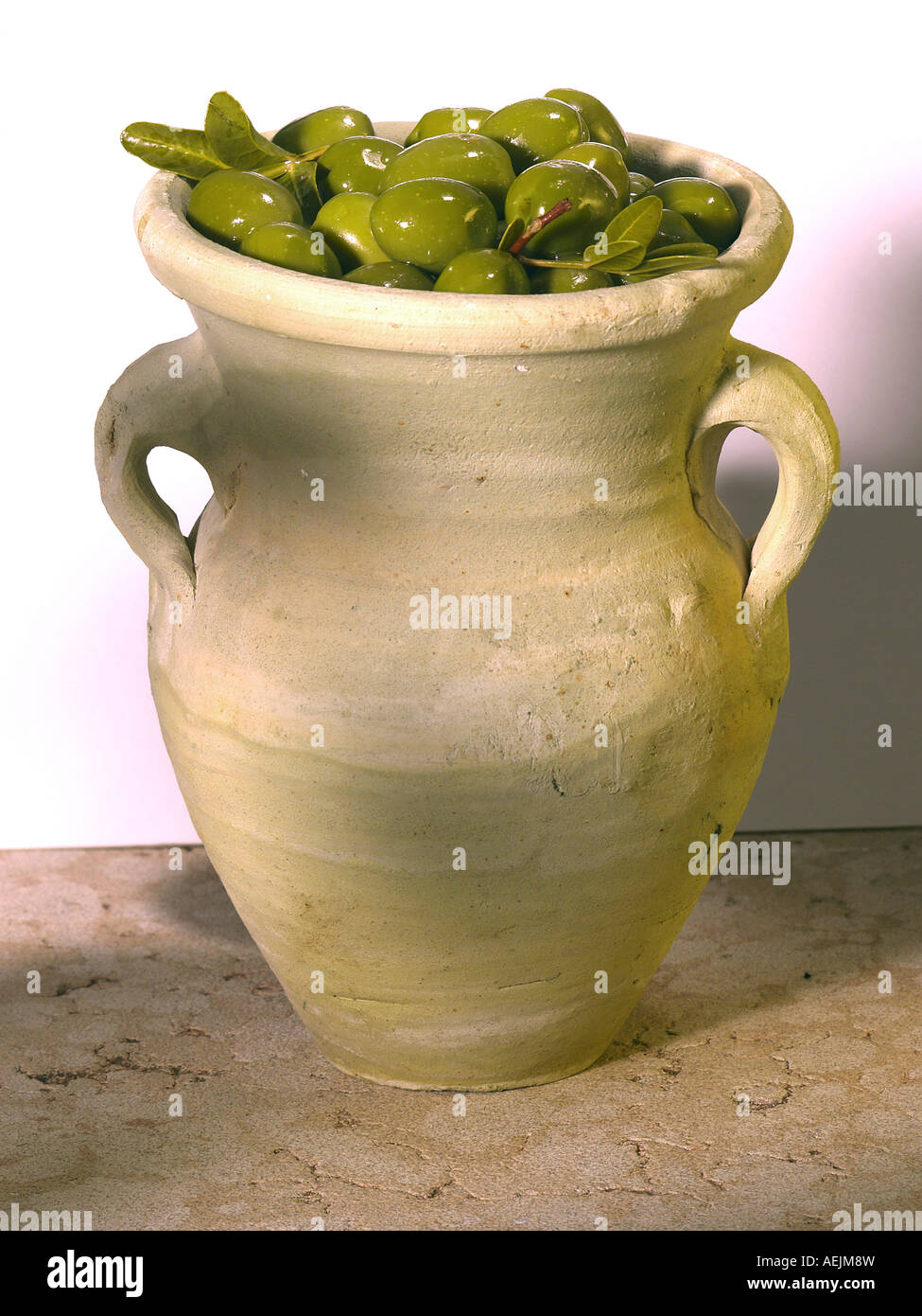 Green olives in a clay jar Stock Photo - Alamy