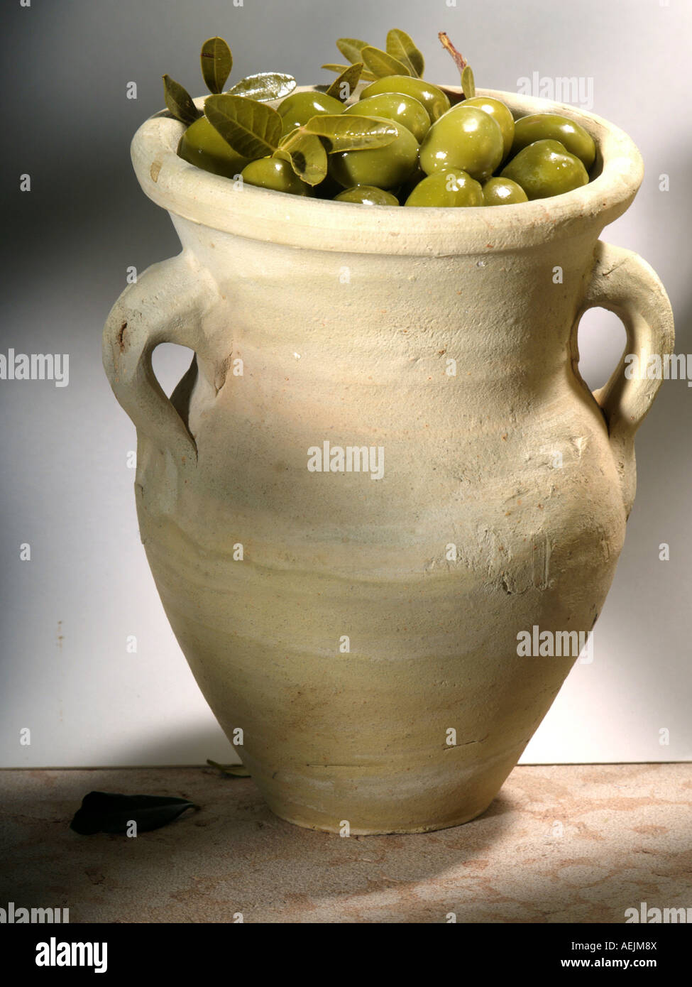 Green olives in a clay jar Stock Photo - Alamy