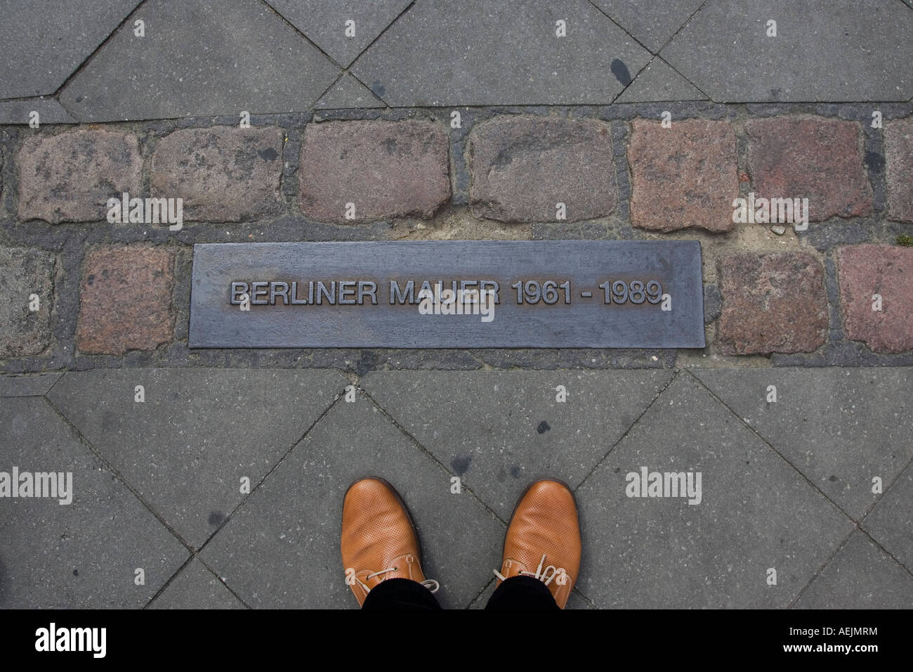 Sign on a sidewalk in Berlin, Germany showing where the Berliner Wall ...