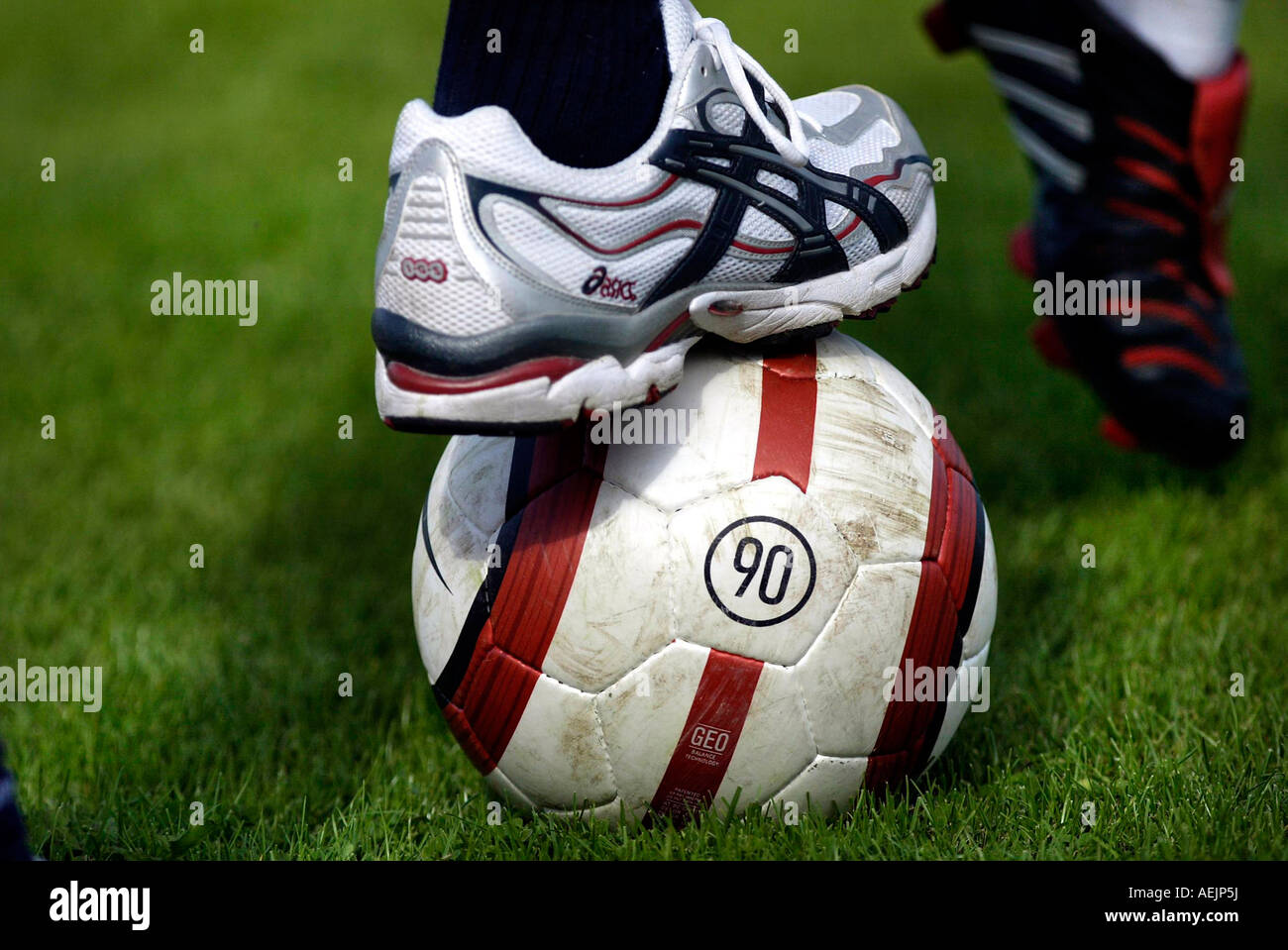 A shoe with a soccer ball Stock Photo - Alamy