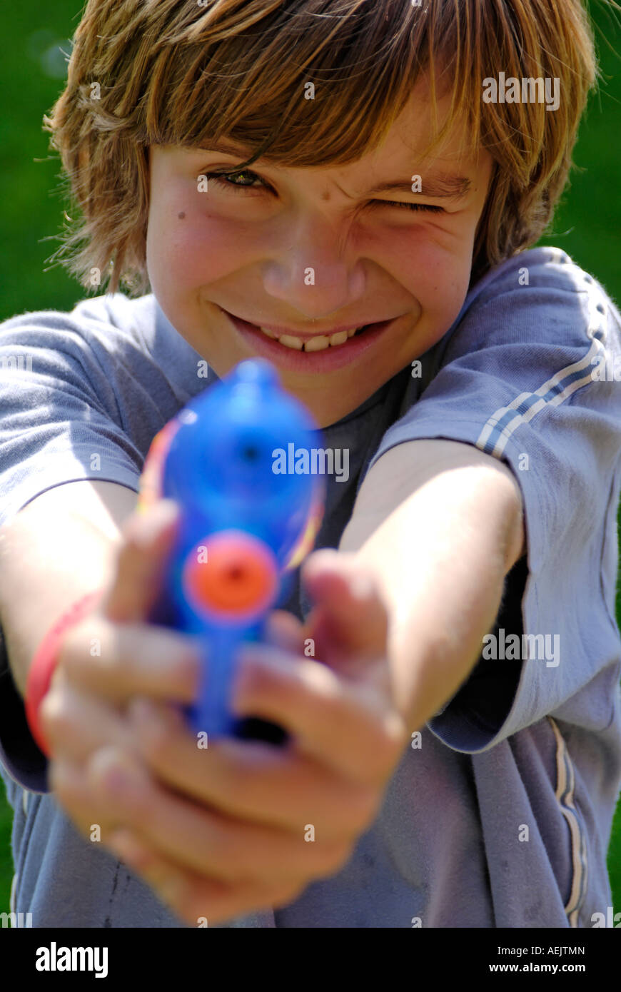 Boy fires with a toy gun pistol Stock Photo - Alamy