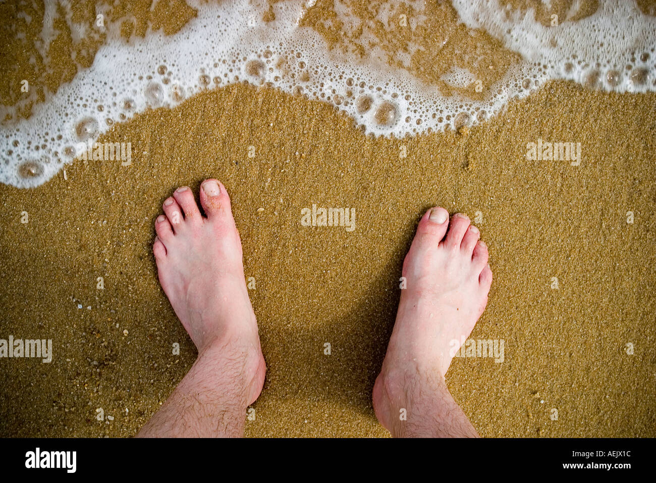 Feet in the sand Stock Photo - Alamy